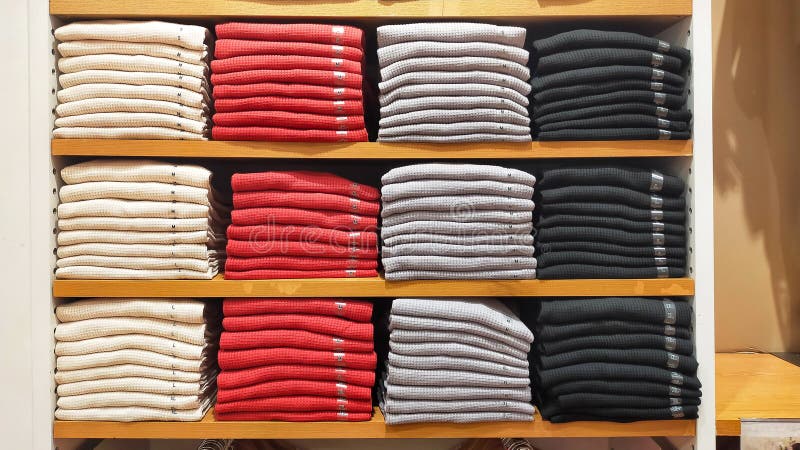 Stack of Cloth Ready To Sell in the Shelf at the Mall or Clothing Store ...