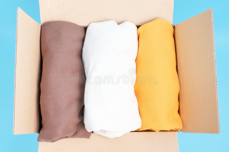 Stack of Clothes in Cardboard Box Top View, Moving Concept. Stock Photo ...