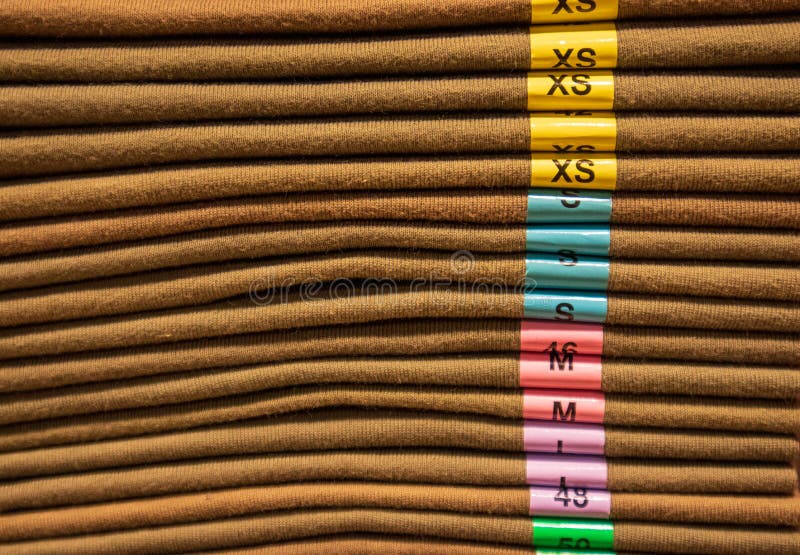 A Stack of Clothes of Different Sizes in a Store Stock Photo - Image of ...