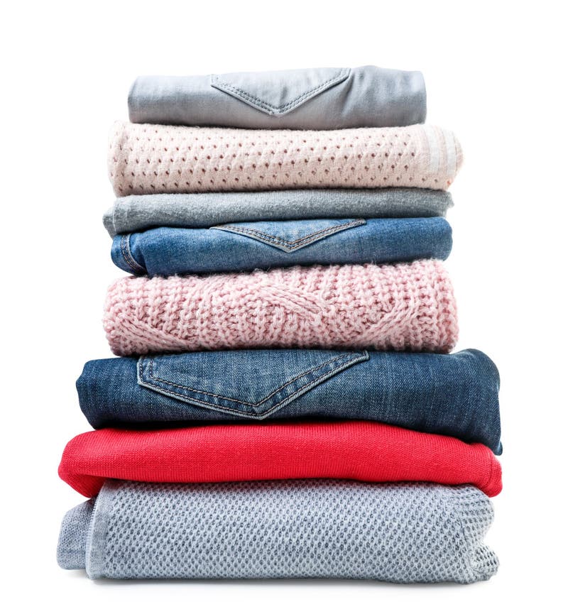 Stack of Clothes Sweaters and Jeans on a White Background. Isolated ...