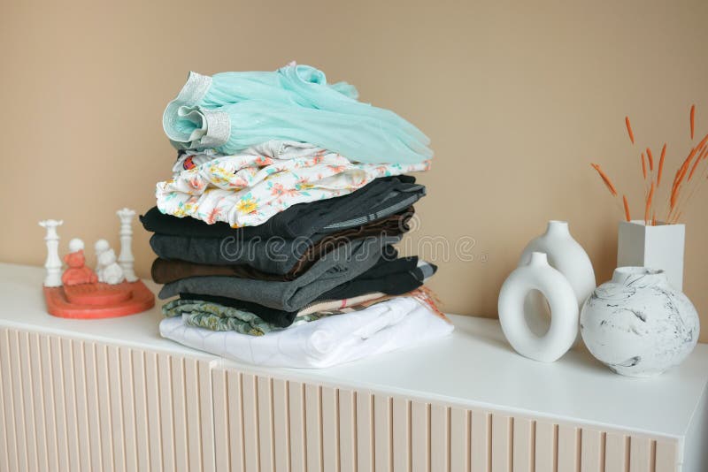 Stack of Clothes on Table Indoor. Stock Photo - Image of group ...