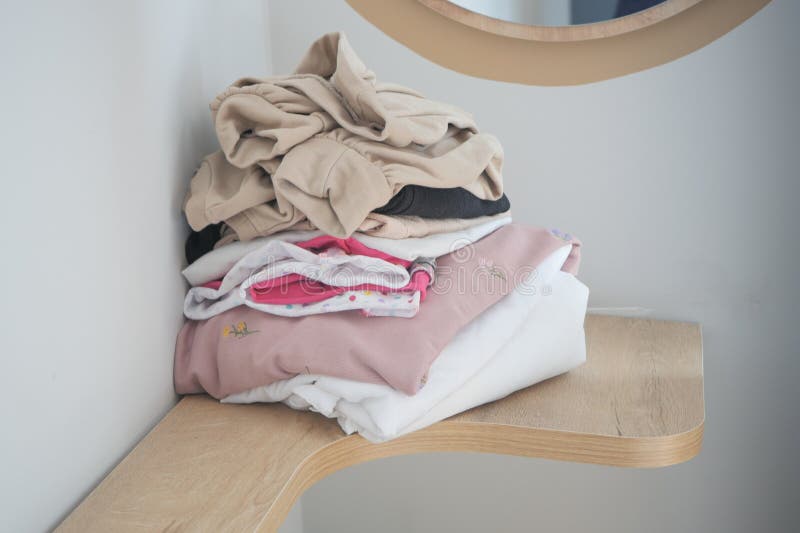 Stack of Clothes on Table Indoor. Stock Photo - Image of household ...