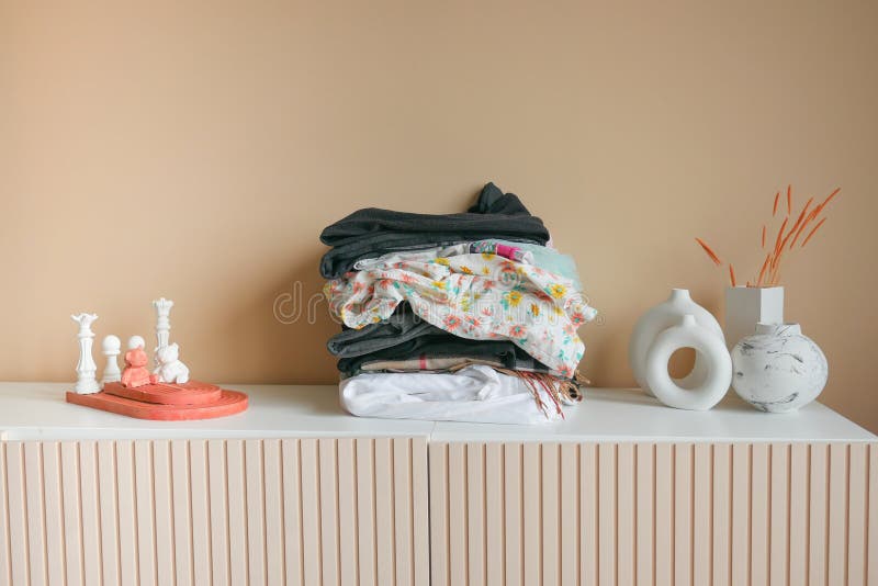Stack of Clothes on Table Indoor. Stock Image - Image of folded ...