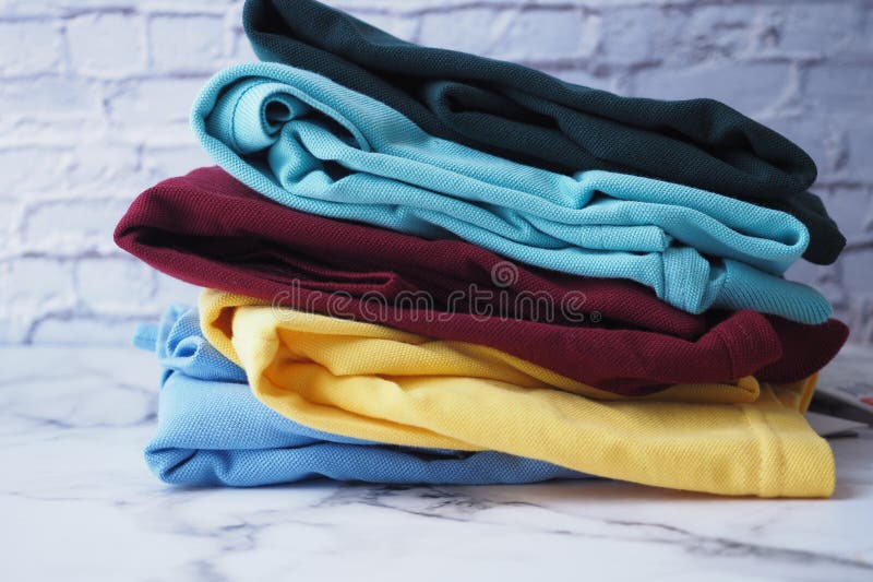 Stack of Clothes on Table Indoor. Stock Image - Image of collection ...
