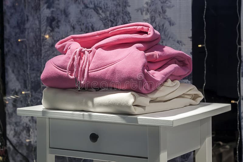 Stack of Clothes on White Table Indoors Stock Image - Image of folded ...