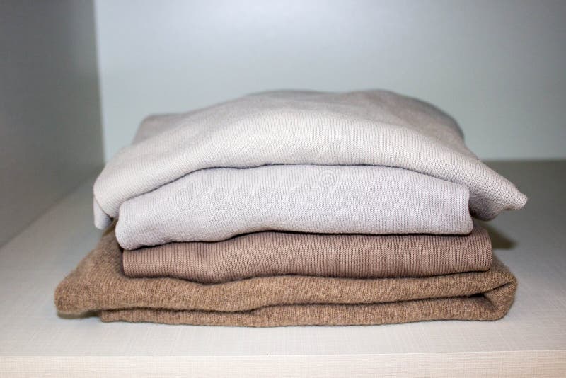 Stack of Clothing Sweaters in of the Wardrobe. Concept of White Stock ...