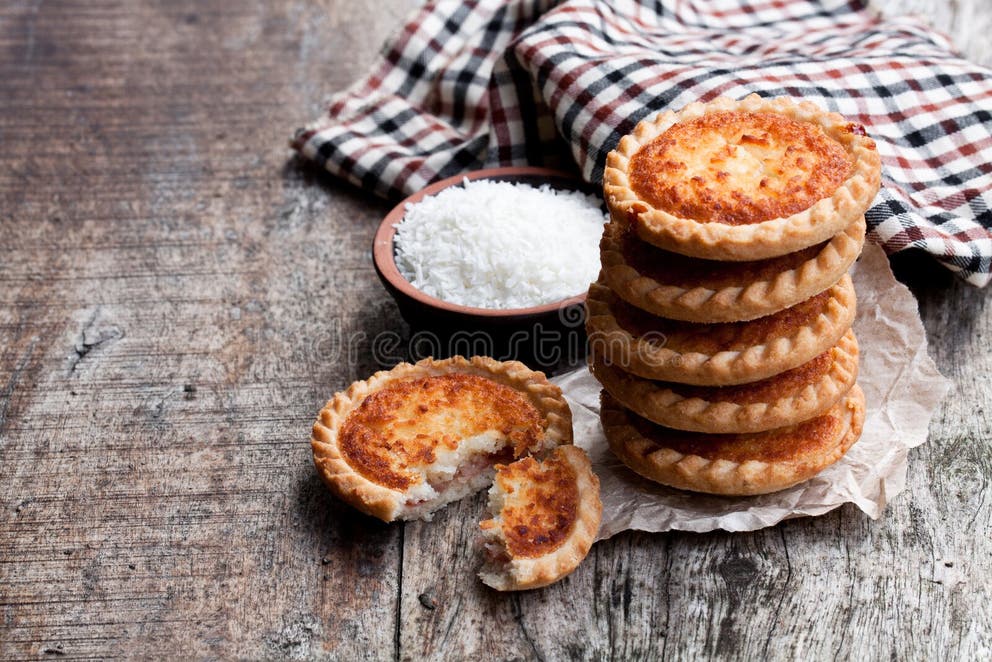 Stack of Coconut Tarts on Wooden Table Stock Image - Image of coconut ...