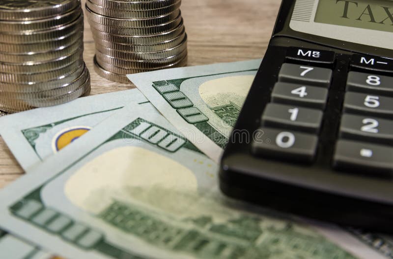 Stack of Coins with Calculator and Dollars on a Wooden Table in the Office, Concept of ...