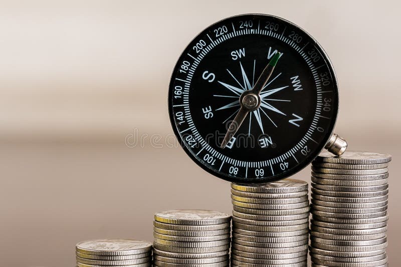 Stack of Coins with Compass on Wood Table Stock Photo - Image of growth ...