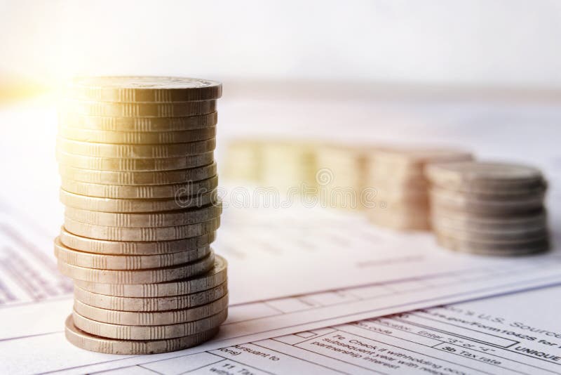 A Stack of Coins in Financial Documents Stock Photo - Image of ...