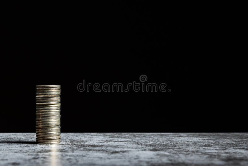 Stack of Coins on Grey Table and Black Background with Copy Space Stock ...