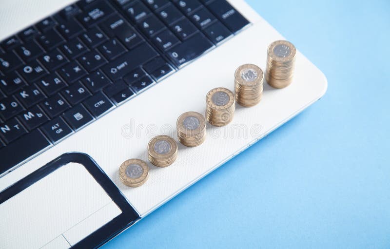 Coins on the Laptop Keyboard with Profit Graph Stock Photo - Image of ...