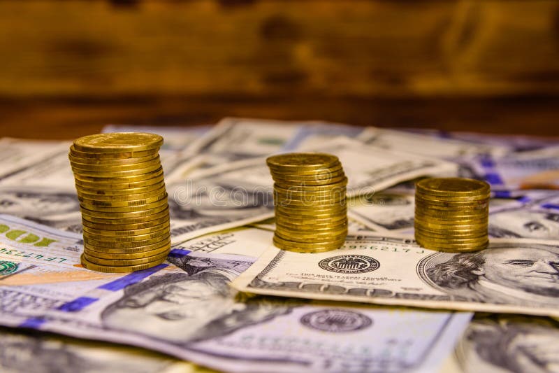Stack of the Coins on the One Hundred Dollar Bills Stock Photo - Image ...