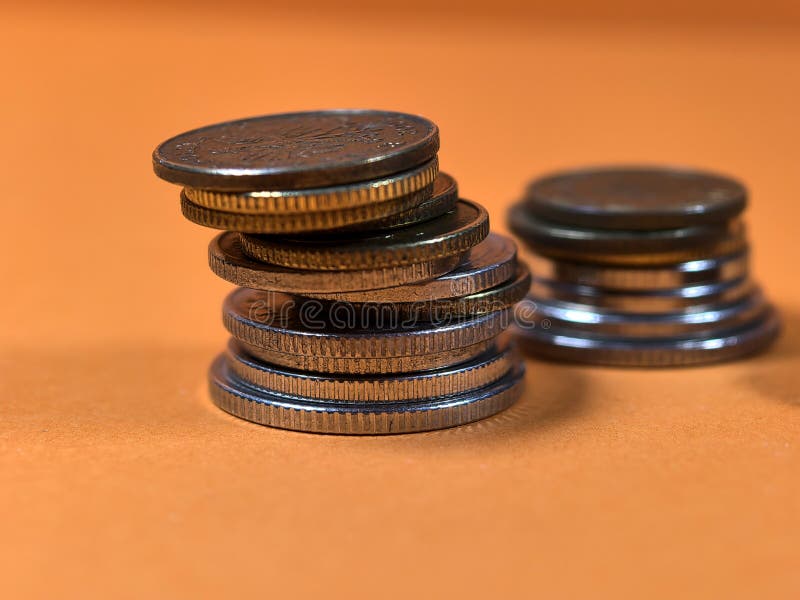 Stack of Coins on Orange Background, Business and Finance Concept Idea ...