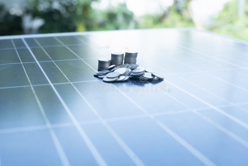 Stack of Coins on Solar Panel the Idea of Installing Solar Cells Gives ...