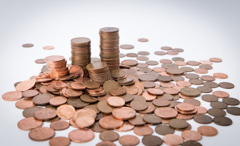 A Stack of Coins Surrounding by Other Coins Spill Around at the White ...