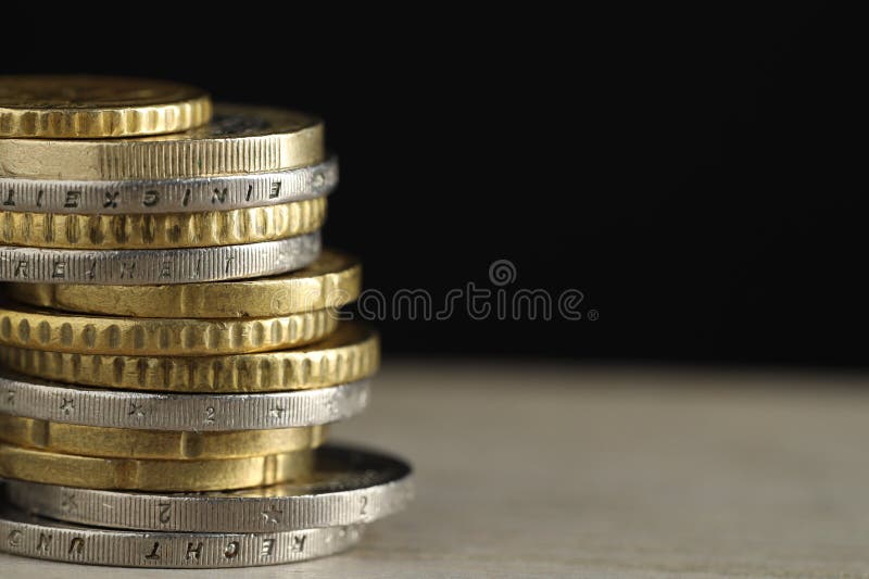 Stack of Coins on Table Against Black Background, Closeup with Space ...