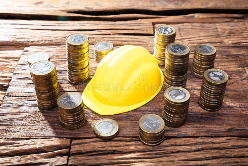 Stack Coins and Yellow Hard Hat on Desk Stock Photo - Image of economy ...
