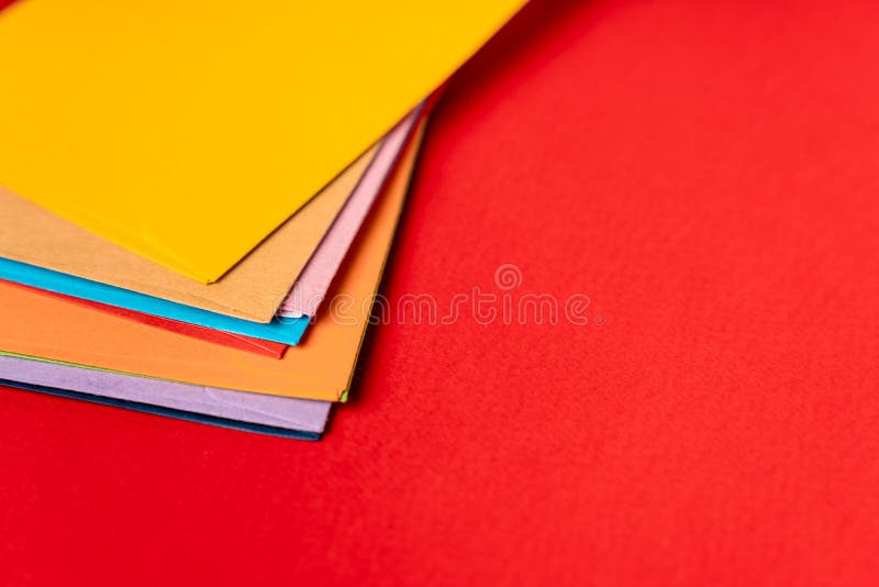 A Stack of Colored Envelopes on a Red Background Stock Photo - Image of ...