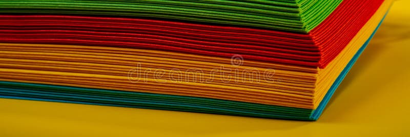 Stack of Colored Paper Envelopes on a Yellow Background Stock Photo ...
