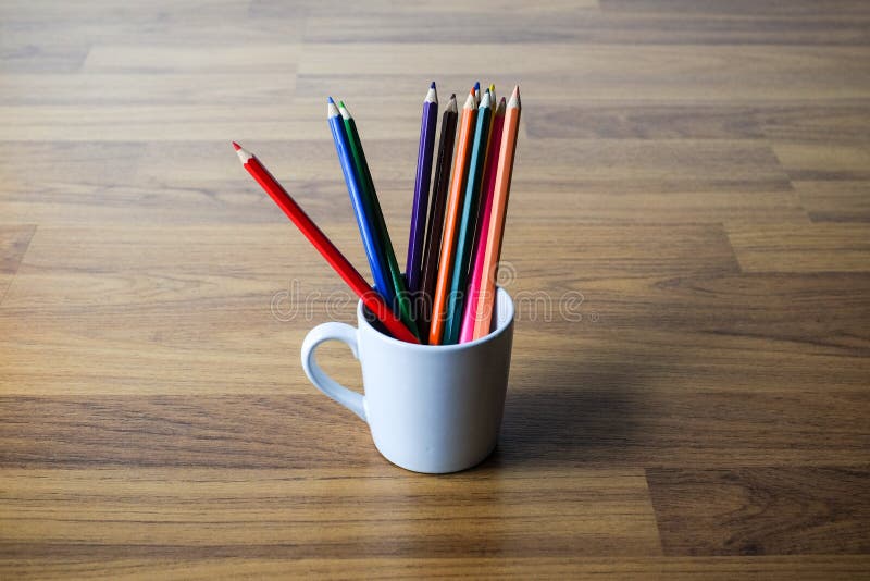 Stack of Colored Pencils in a Glass on Wooden Background. Stock Photo ...