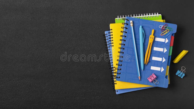 A Stack of Colored School Notebooks and an Alarm Clock on a School ...