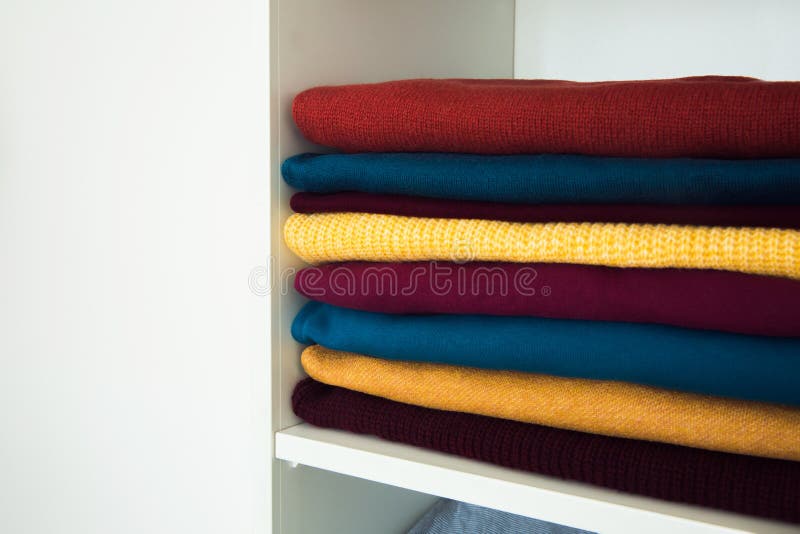 A Stack of Colored Things, Clothes, Neatly Stacked on a Shelf in a ...