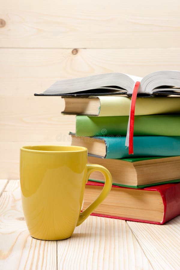 Stack of Colorful Books, Open Book and Cup on Wooden Table Stock Photo ...