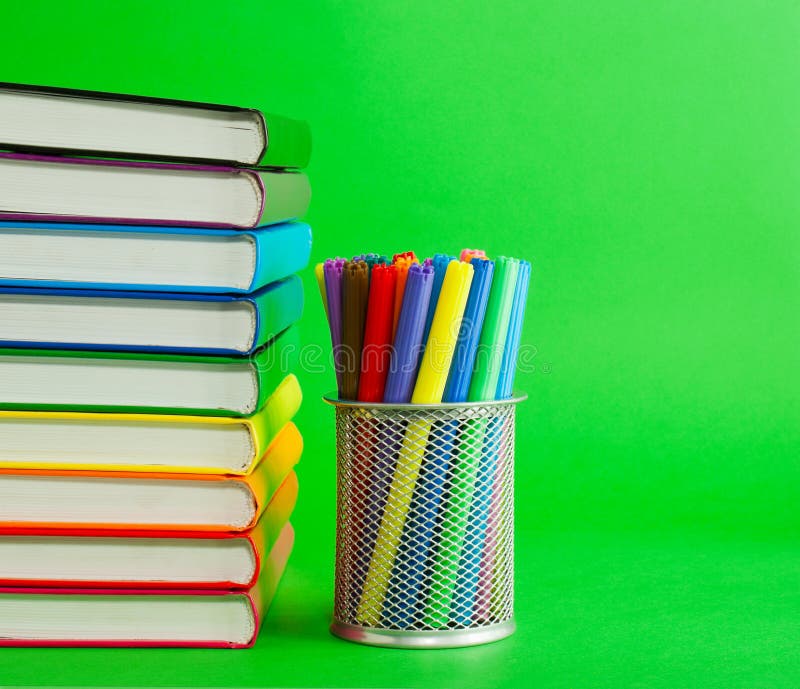 Stack of Colorful Books and Socket with Felt Pens Stock Photo - Image ...