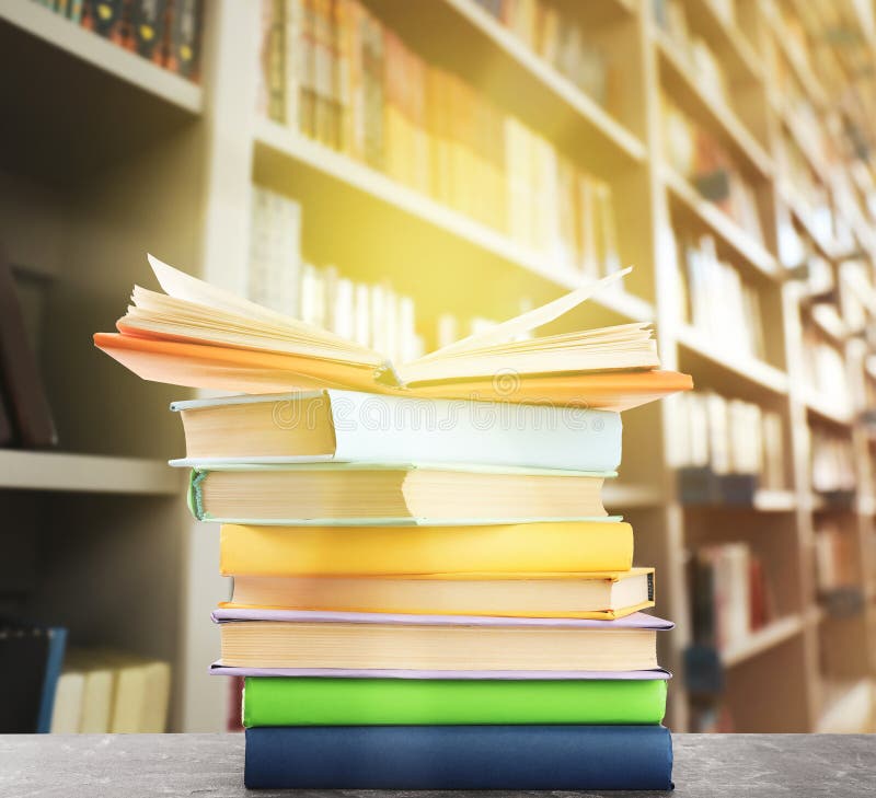 Stack of Books on Table in Library Stock Photo - Image of bookworm ...