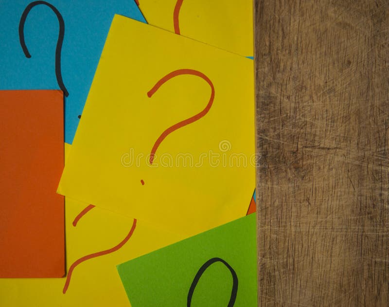 Stack of Colorful Cards with a Question Mark on the Old Wooden ...