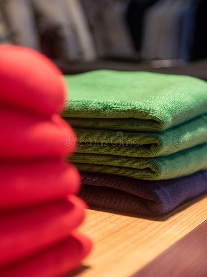 Stack of Colorful Clothes in a Boutique. Merchandising Clothing Store ...
