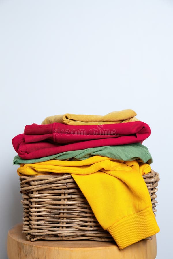 Stack of Colorful Clothes on Wicker Basket Stock Photo - Image of clean ...