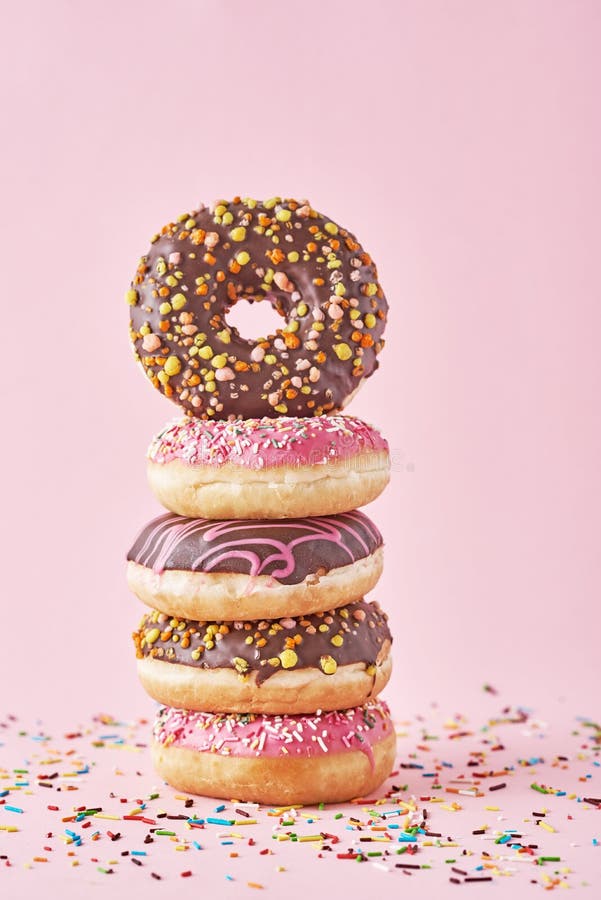 Stack of Colorful Donuts Decorated and Glass of Milk on a Pink ...