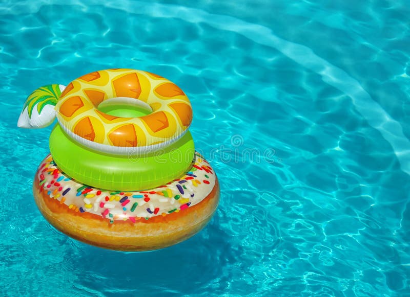 Stack of Colorful Inflatable Rings Floating in Swimming Pool on Sunny ...