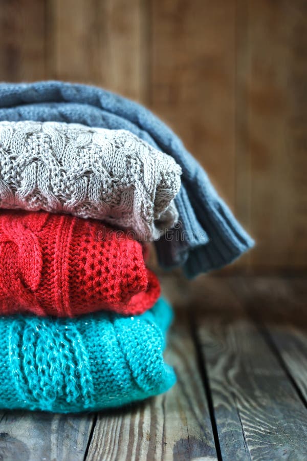 Stack of Colorful Knitted Sweaters on Wooden Stock Photo - Image of ...