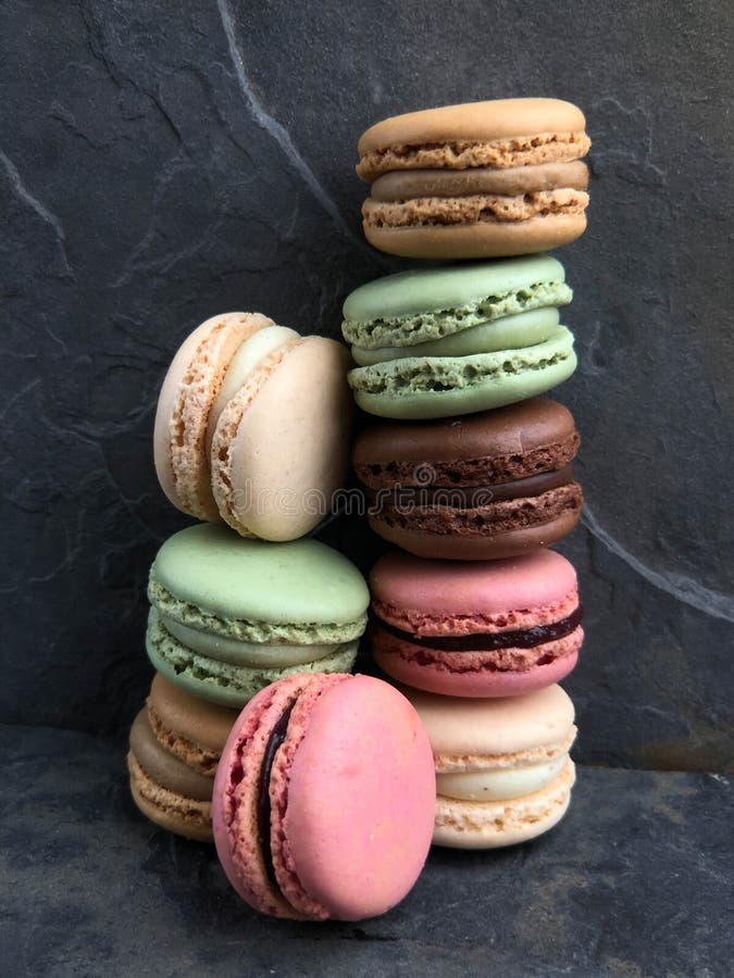 A Stack of Colorful Macarons, Arranged in a Tower on a Dark Stone ...