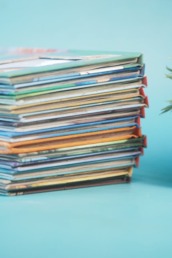 Stack of Colorful Magazines Resting on a Light Blue Surface Stock Photo ...