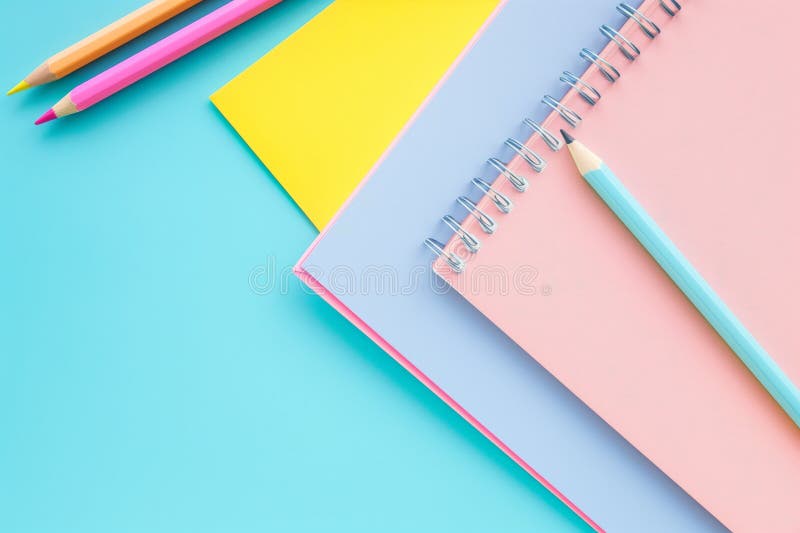 A Stack of Colorful Notebooks and Pencils on a Blue Background Stock ... A Stack of Colorful Notebooks and Pencils on a Blue Background Stock ...
