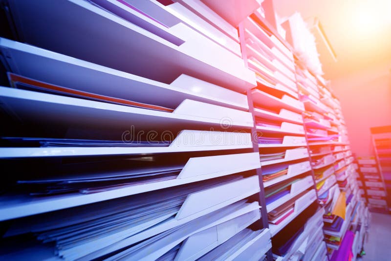 A Stack of Colorful Paper Folded in a Warehouse Stock Photo - Image of ...