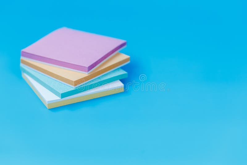 Stack of Colorful Square Notes on Blue Background Stock Image - Image ...