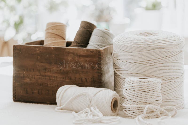 Stack of Colorful Thread Spools in a Wooden Box Set Against a White ...