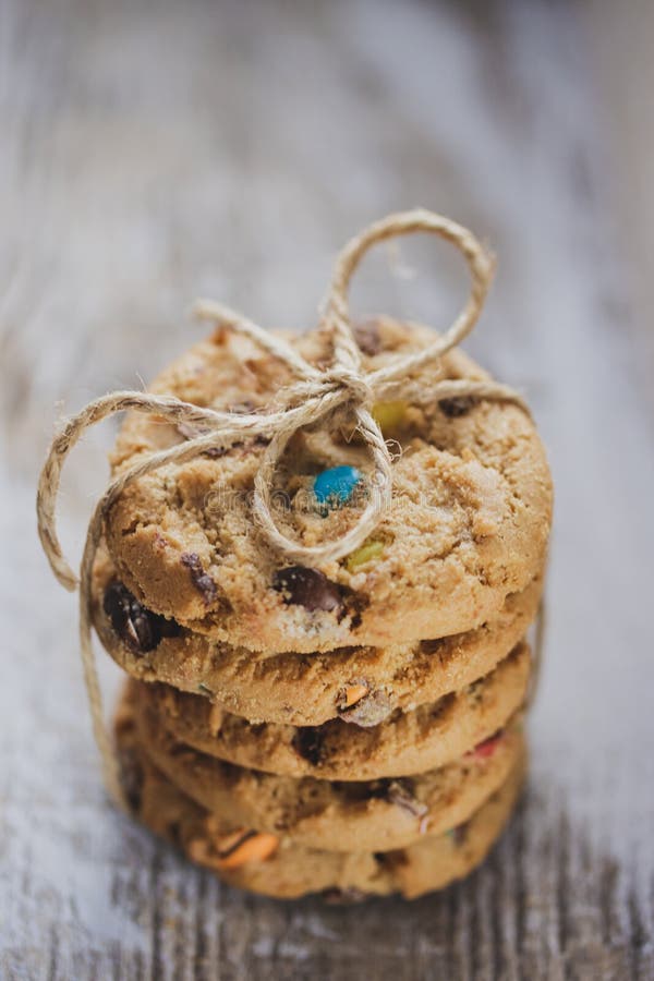 Stack of Cookies with Colorful Chocolate Candies on White Wooden ...