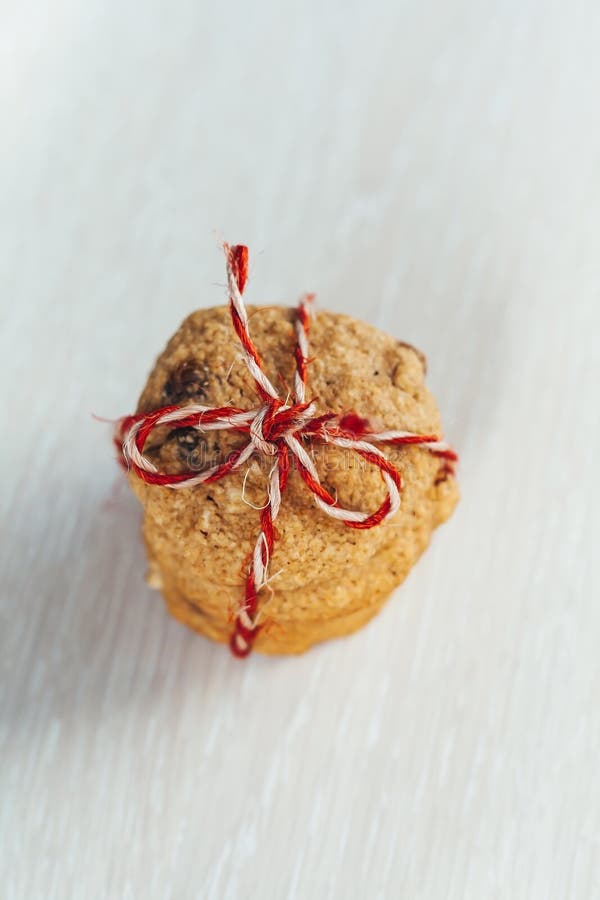 A Stack of Cookies Tied with a Jute Rope. Next To it is a Glass of Milk ...