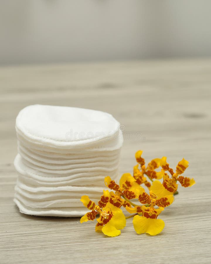 A Stack of Cotton Pads with a Yellow Orchids Stock Image - Image of ...
