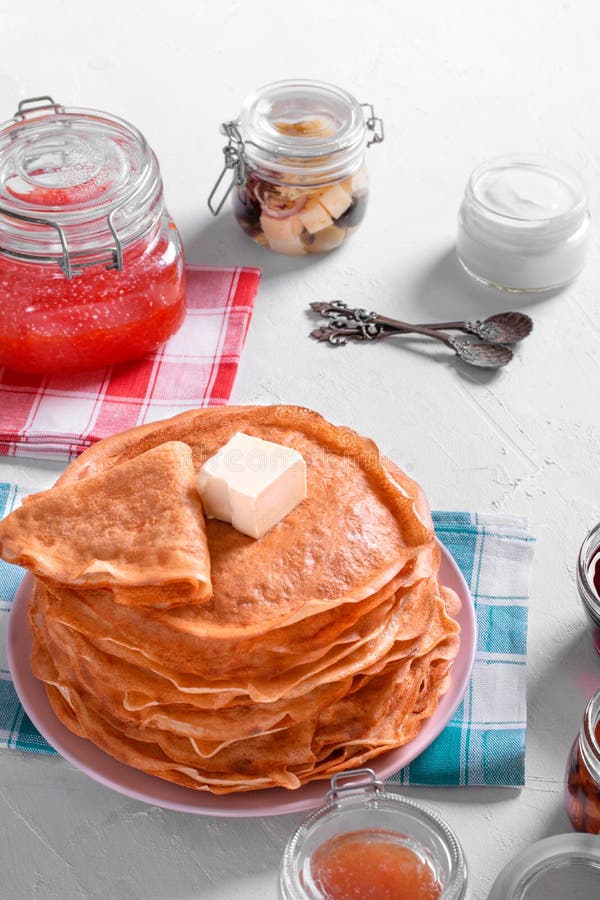 Stack of Crepes with Piece of Butter and Various Toppings Around Stock ...