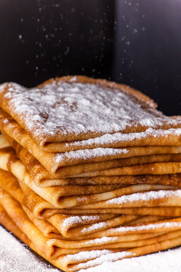 Stack of Crepes with Powdered Sugar on Dark Background. Stock Image ...