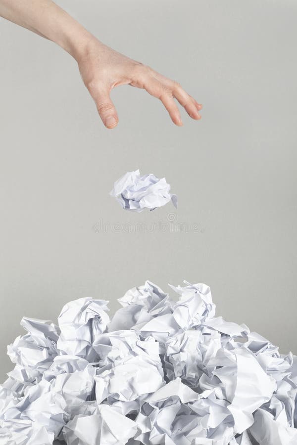 Stack of Crumpled Paper Balls and Hand on Gray Stock Photo - Image of ...