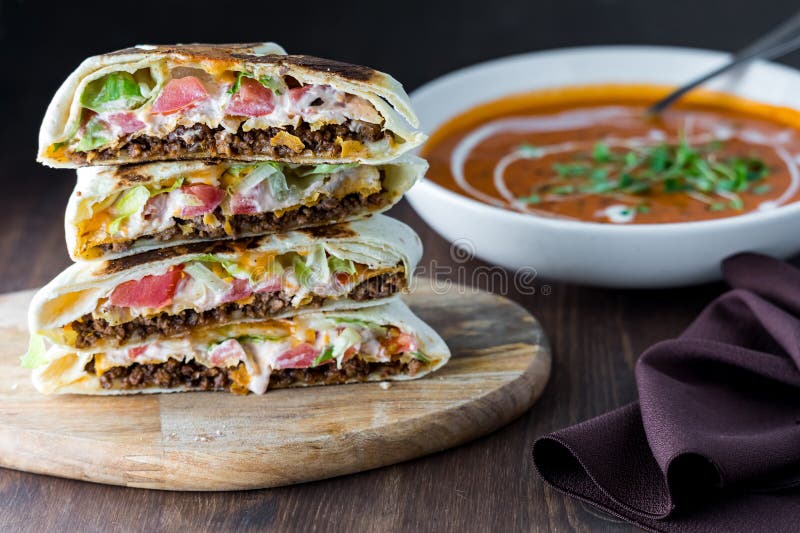 A Stack of Crunch Wraps Served with a Bowl of Roasted Red Pepper Soup ...