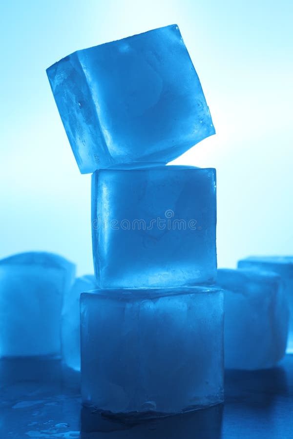Stack of Crystal Clear Ice Cubes on Light Blue Background. Color Tone ...